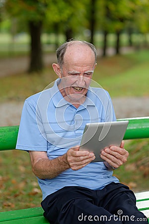 Old man on tablet computer stock photo. Image of joyful - 25013650