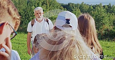 Front View of Old Man Wearing Rucksack, Standing in Front of Children ...