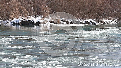 Frozen Ice River is Melting in Spring with Ice Flakes Flowing. Cracked ...