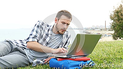 Frustrated Student E Learning with a Laptop on the Grass Stock Video ...