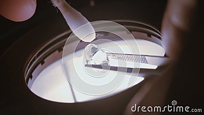 A Gemologist Inspecting a Large Diamond Under a Microscope Stock Video ...