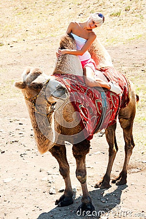 A Girl Riding A Camel Stock Photos - Image: 27049733