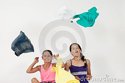 Girls Throwing Clothes In The Air Stock Photo - Image: 62641072