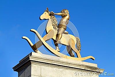 Golden Statue Of Young Child On Rocking Horse Editorial Image ...