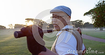 Golfer Carrying Golf Club Over Shoulder while Standing on the Golf ...
