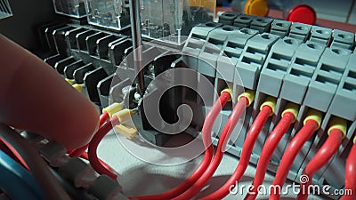 Gray Plastic Electrical Panel with Many Red Wires, Yellow Bushing ...