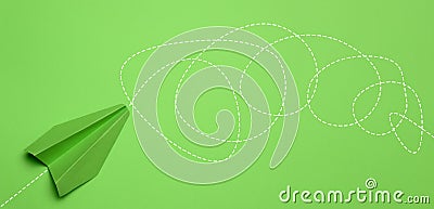 A Green Paper Airplane On A Green Background With A Long And Convoluted ...