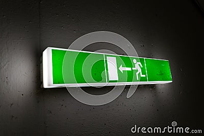 Green Escape Exit Sign On White Concrete Wall Royalty-Free Stock ...