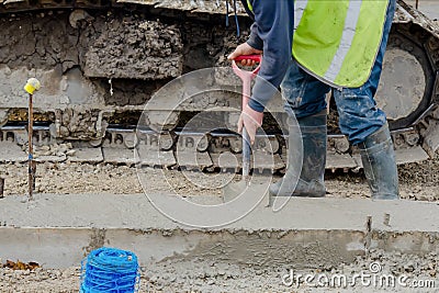 Groundworker Placing Wet Concrete Inside Formwork During Roadworks ...