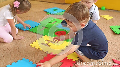 Group of Children Playing with a Large Soft Puzzle Stock Video - Video ...