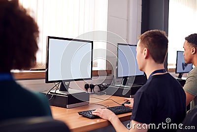 Group Of College Students Studying Computer Design Sitting At Line Of ...