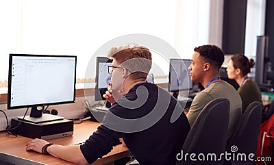 Group Of College Students Studying Computer Design Sitting At Line Of ...