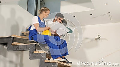 Group of Construction Workers Watching Some Details on a Blueprint ...