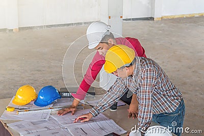 Group Of Engineer Checking The Blueprint On The Table And Talking About ...