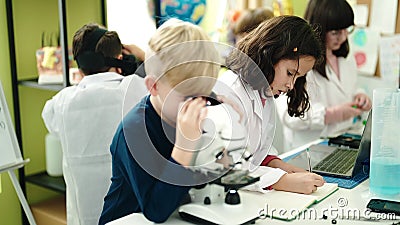 Group of Kids Students Using Microscope Writing on Notebook at ...