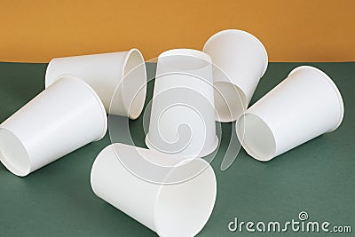 Group Of Paper Cups Laying On Green Table. Cup Stacking Fail Attemp ...