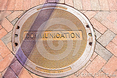 Grungy Manhole Cover That Says Communication And USA In Brick Sidewalk ...
