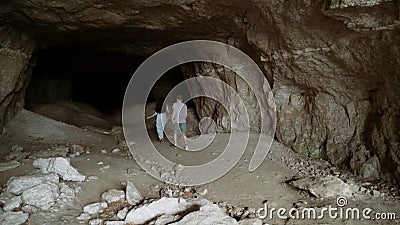 A Guy and a Girl are Running into a Huge Cave. the Girl Runs Away from ...