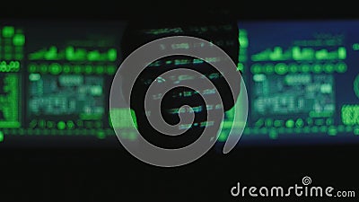 Man Hacker Programmer Working at Computer while Green Code Characters Reflect on His Face in ...