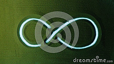 Hand Drawing The The Infinity Symbol In The Green Sand. Royalty-Free ...