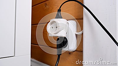 Overloaded Outlet with an Extension and Many Sockets Plugged in, a Hand ...