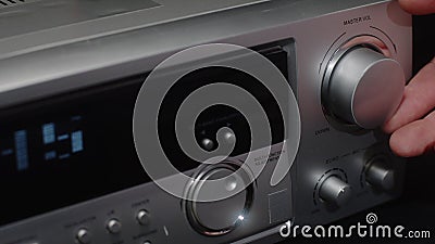 The Hand Turns the Volume Control on the Music Device. Turning Down the ...