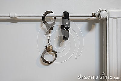 Handcuffs On The Radiator. Police Handcuffs And Collar Royalty-Free ...