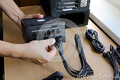 Hands Connect Wires To Power Supply Unit While Assembling Computer ...