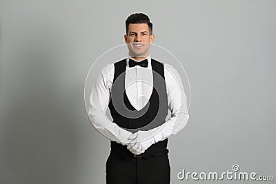 Handsome Butler In Elegant Uniform On Grey Background Stock Photography ...