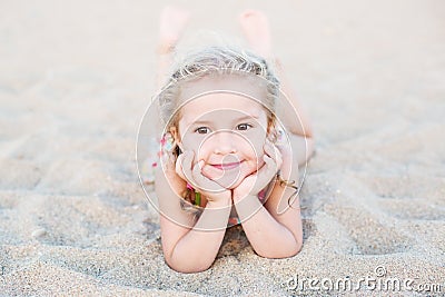 Happy Little Girl Lying On The Sand Stock Photo - Image: 55218850