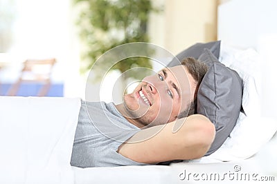 Happy Man Resting On A Bed Stock Photo - Image: 79555050