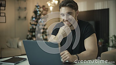 Happy Man Working on Laptop Computer at Christmas. Smiling Guy Looking ...