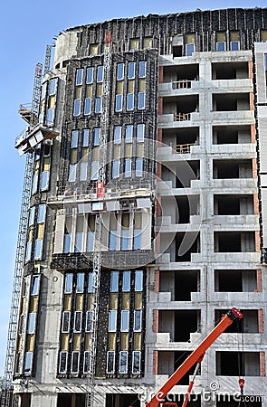 High-rise building under construction with a waterproofing and warming ...