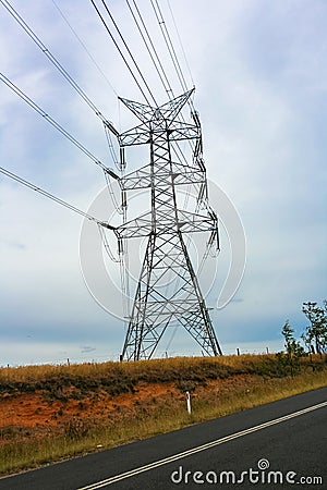 High Voltage Powerline Tower With Road In Forground. Stock Photo ...