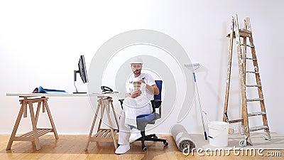 House Painter Man with a Computer Talk on the Phone, Looks at Color ...