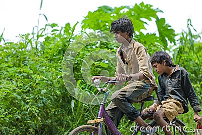Indian Poor Child On Cycle Editorial Image | CartoonDealer.com #220473494