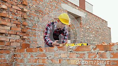 Installing Brick Wall. Construction Worker in Uniform and Safety ...