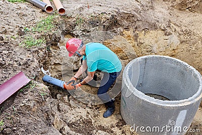 Plumber Inserts Bent Fitting Into Socket Of An Underground Sewer Inlet ...