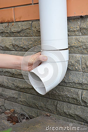 Installing Rain Gutter Downpipe. Contractor Hands Repair Rain Gutter ...