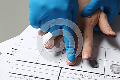 Investigator Taking Fingerprints Of Suspect On Table Stock Image ...
