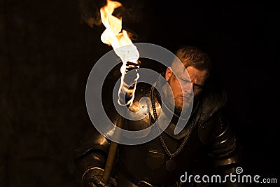 Knight With A Torch At Night On A Wall Background Stock Photo ...