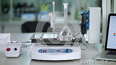 Laboratory Equipment in Modern Lab. Pure Liquid Mixing in Glass Flask ...