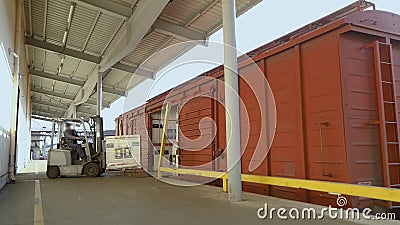A Large Warehouse, Forklift Loads Boxes in the Freight Train. Rail ...