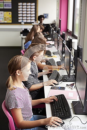 Line Of High School Students Working At Screens In Computer Class With ...