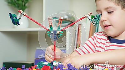 A Little Boy Plays with a Constructor, Creating Figures from Gears and ...