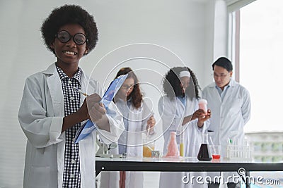 Little Cute And Smart Black Boy Is Taking Notes About The Science ...