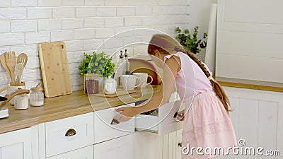 The Girl is Looking for Something in the Kitchen Stock Footage - Video ...