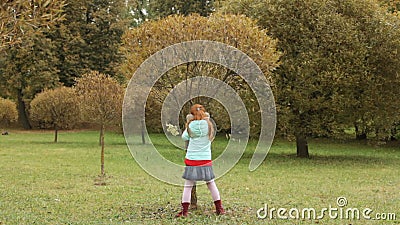 Little Girl Shaking a Tree in the Autumn Park Stock Footage - Video of ...