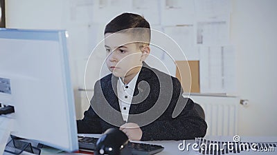 Little Handsome Boy Working with Computer in Office. 4K Stock Video ...