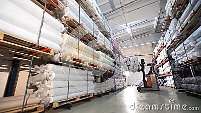 The Loader Unloads Shelves with Material Rolls, Storage of Fabrics in ...